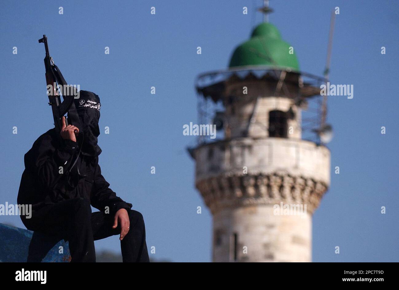 A masked Palestinian militant from the al-Aqsa Martyrs' Brigades, a ...
