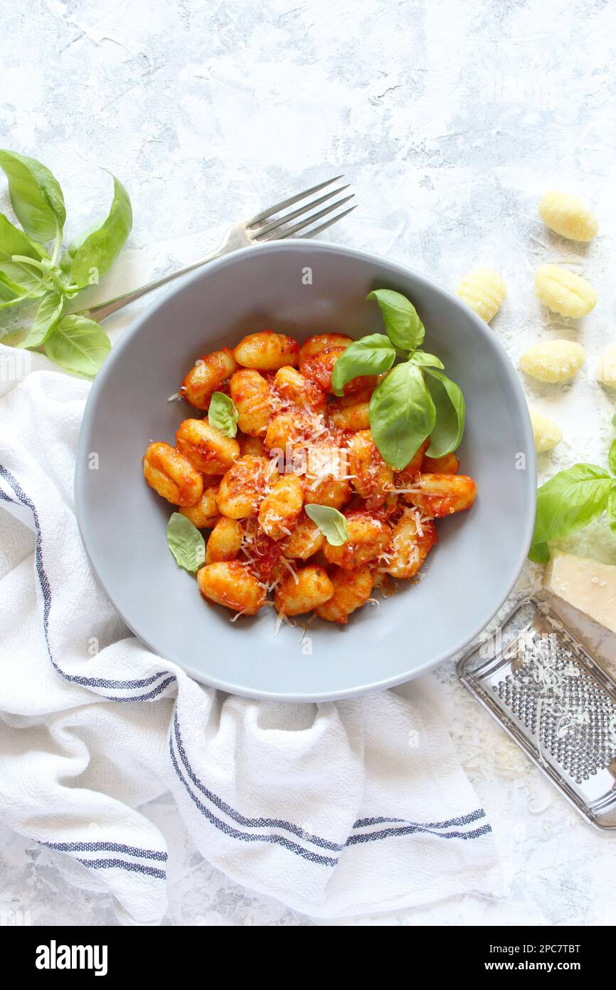 Italian gnocchi with tomato sauce on table. Top view Stock Photo - Alamy