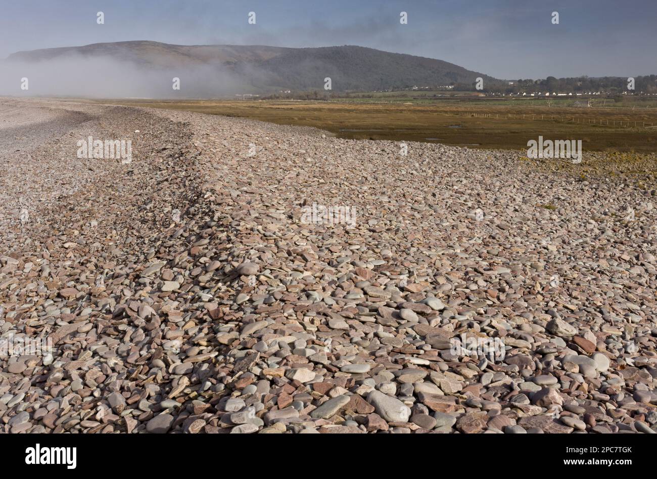View of shingle bank spreading inland as sea levels rise, with ...