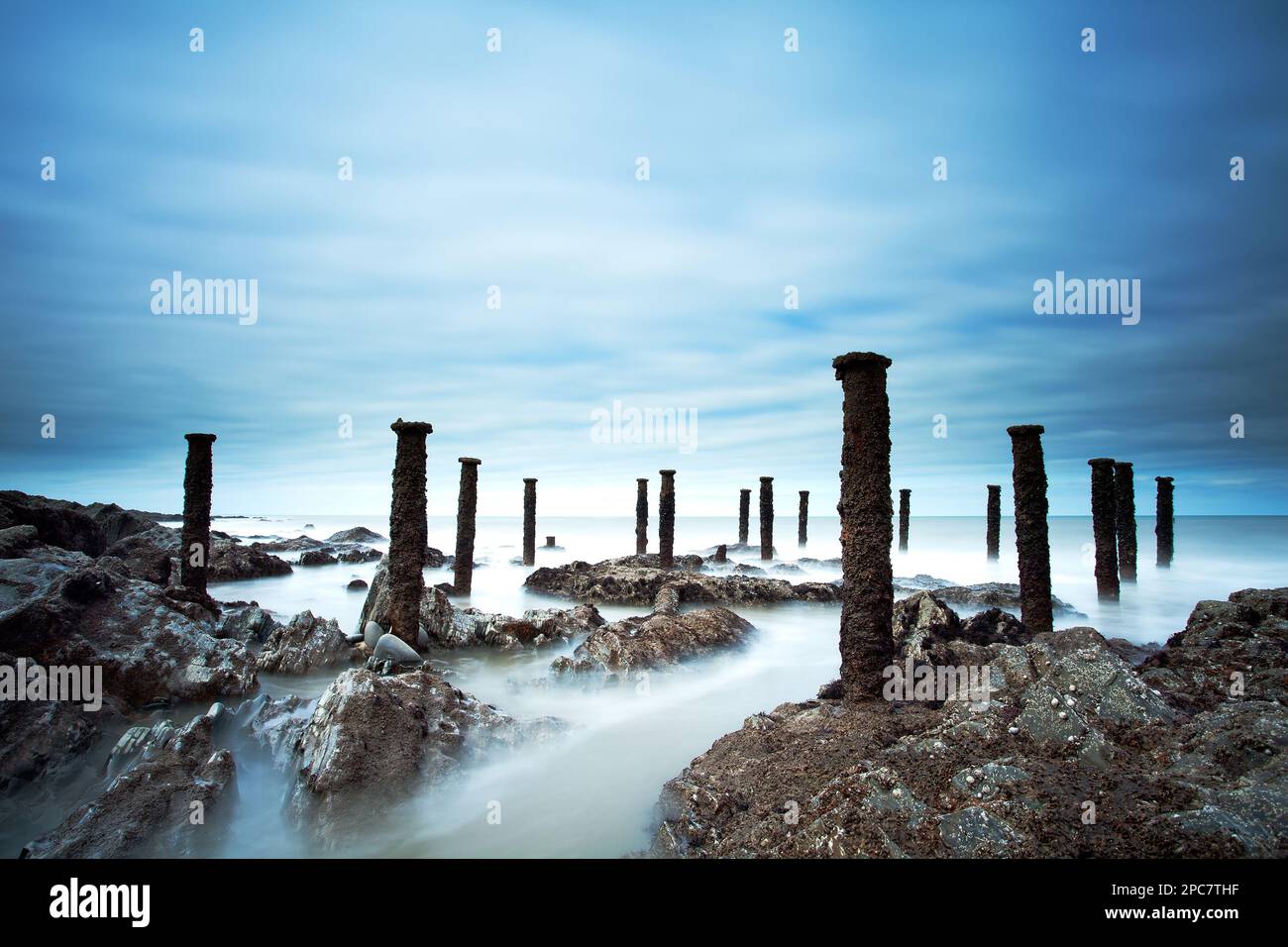 Steel supports of the ruined Victorian pier visible on the shore at low ...