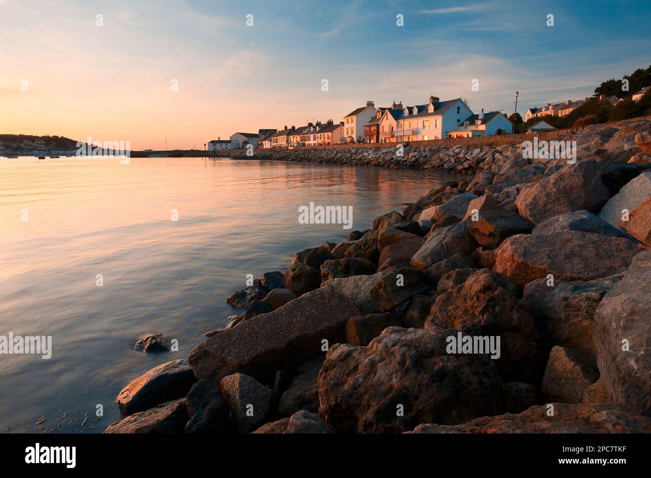 View of the sea wall and houses of a coastal village overlooking the ...