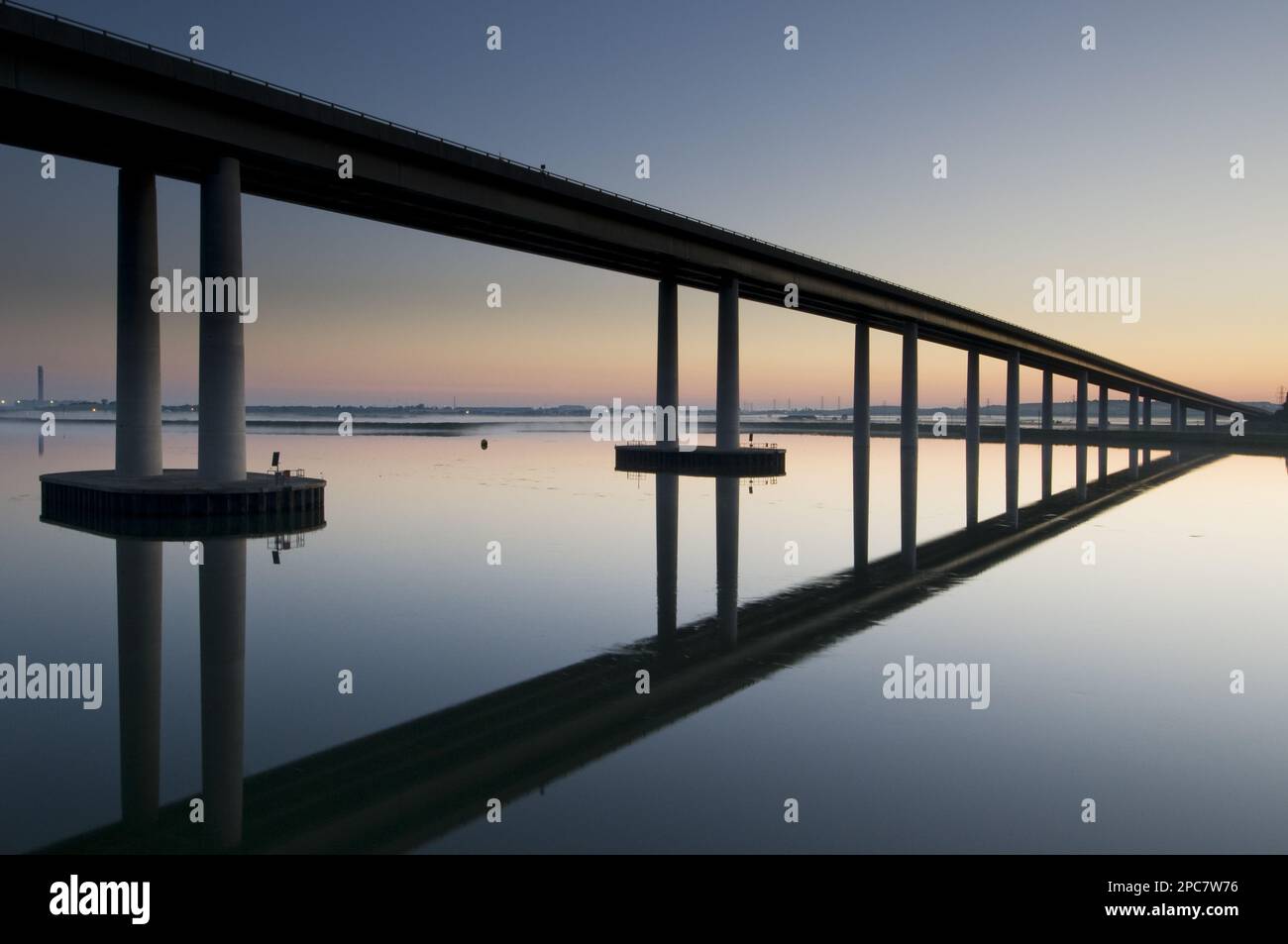 View of the bridge reflected in the estuary at dawn, Sheppey Crossing ...