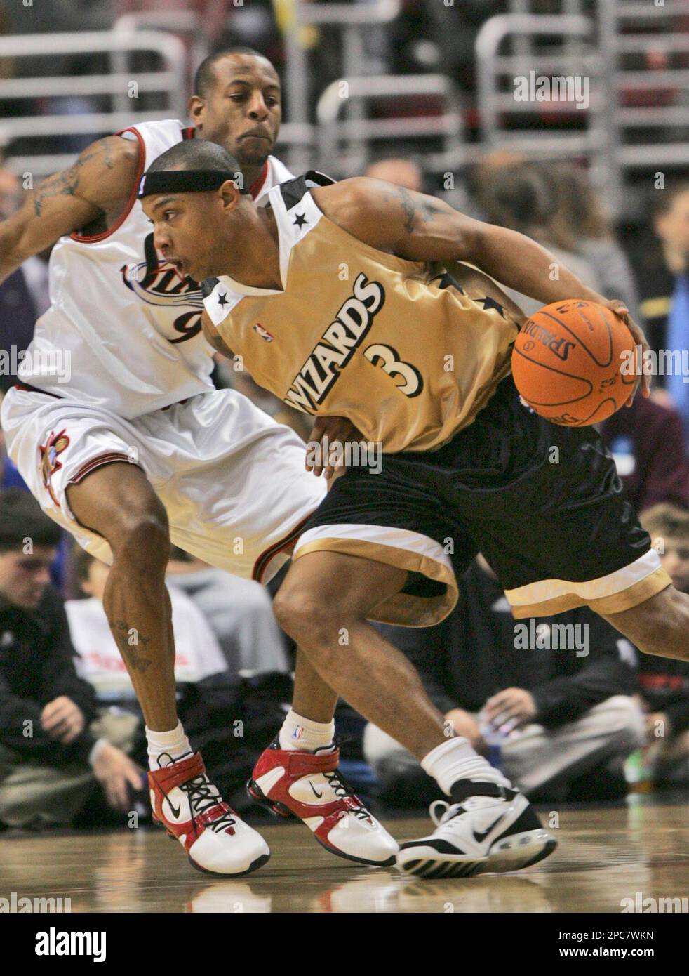 Washington Wizards' Caron Butler goes by Philadelphia 76ers' Andre ...