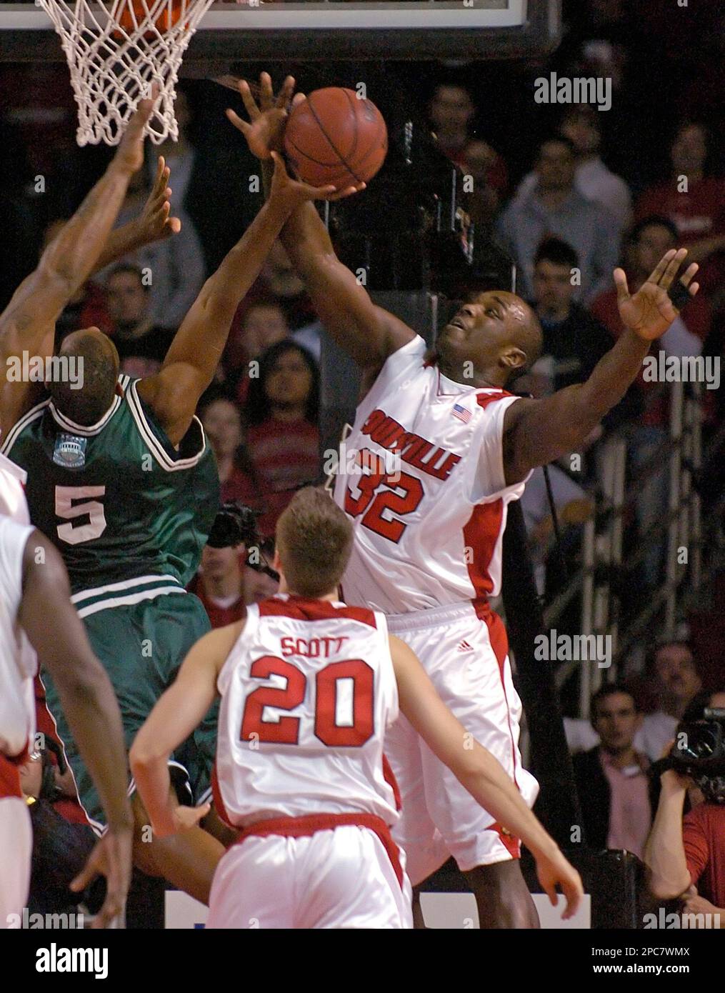 Louisville's Derrick Caracter (32) goes up to block the shot of Ohio's ...