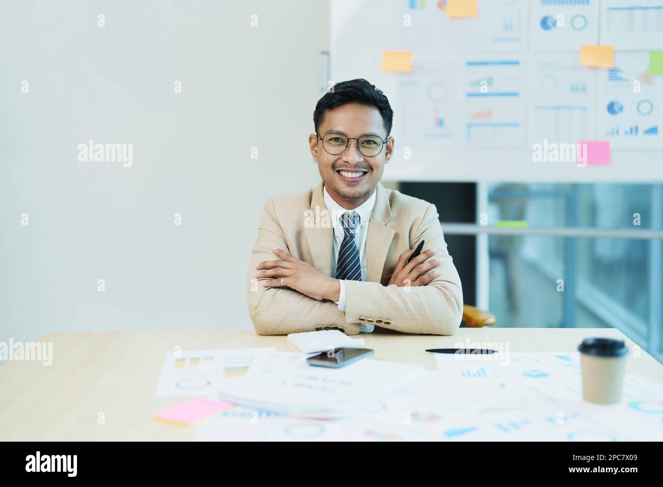 Portrait of a male business owner showing a happy smiling face as he ...