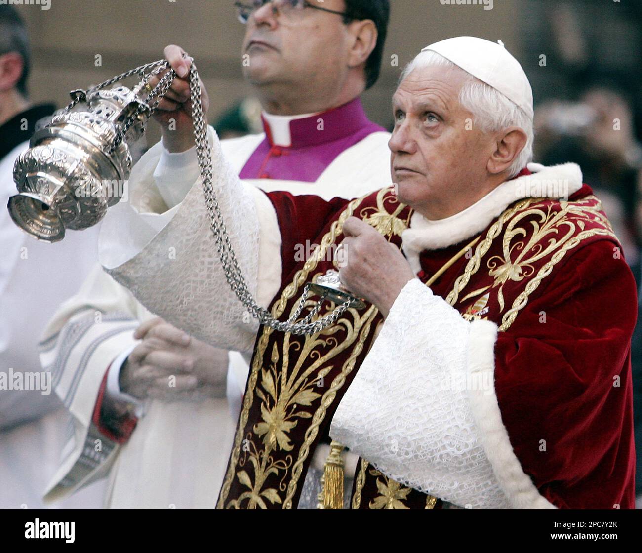Pope Benedict XVI, wearing an ermine-trimmed cape, blesses with incense ...