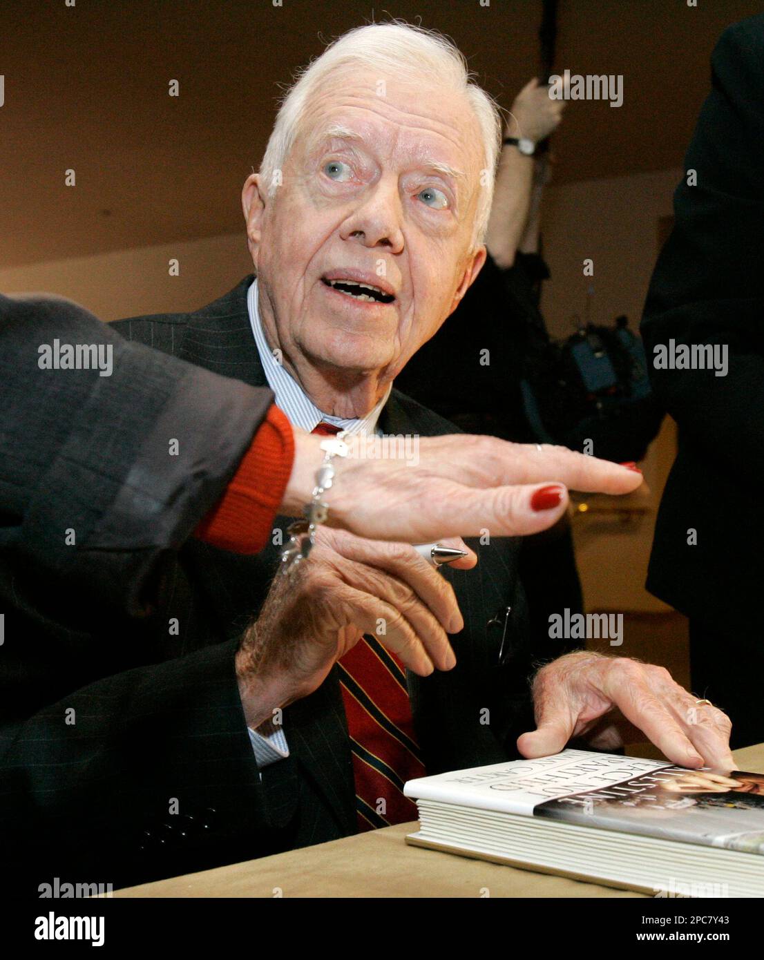 Former President Jimmy Carter signs copies of his book "Palestine ...