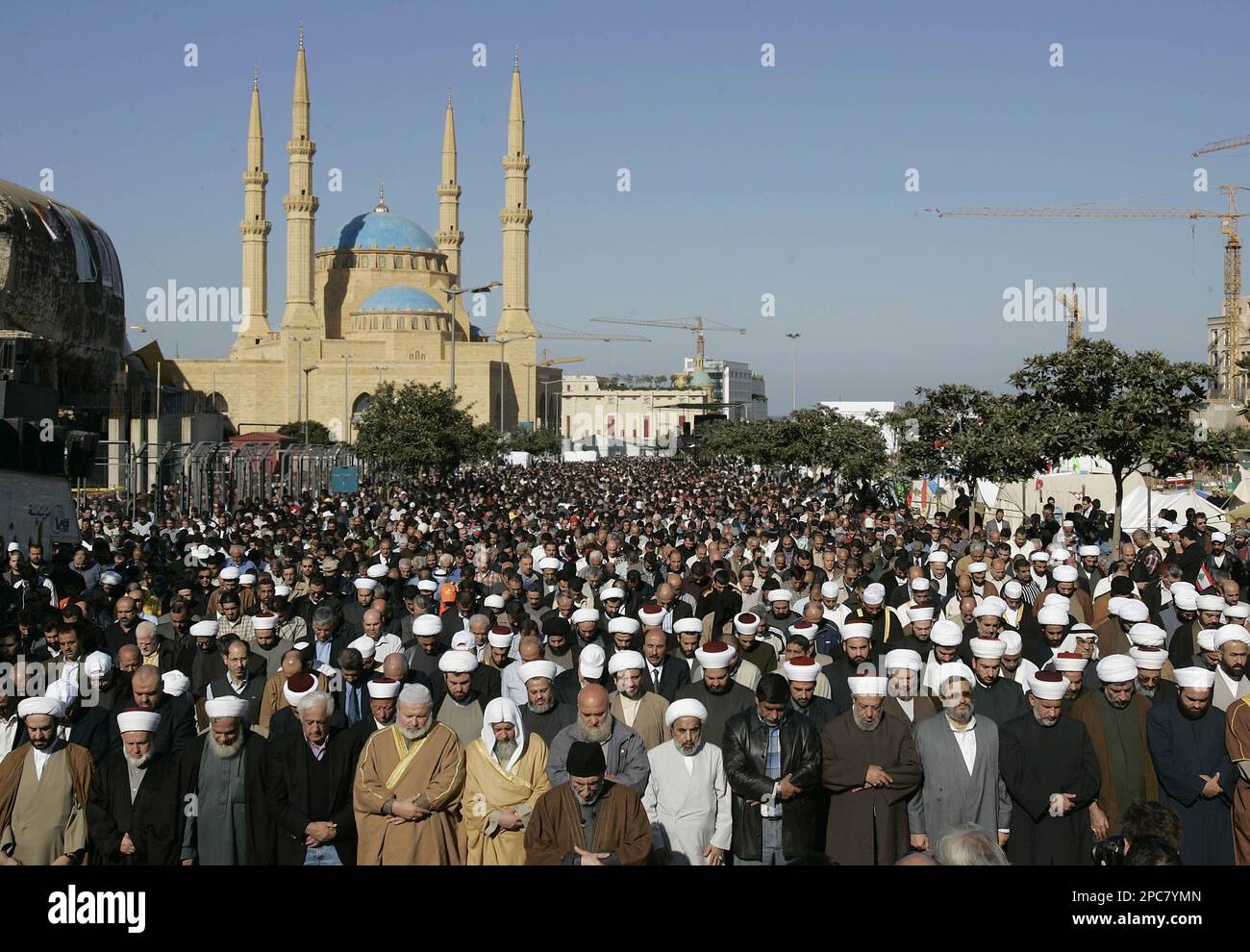 Shiites and Sunnis pray together during Friday Prayers in front ...