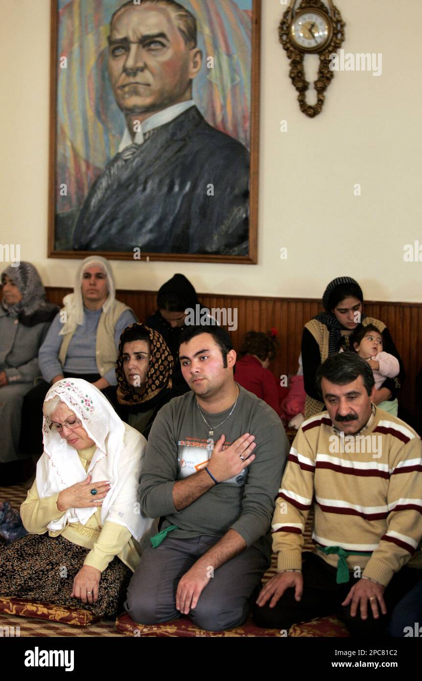 TO GO WITH TURKEY MUSLIM MINORITY - Alevi men and women, with portrait ...