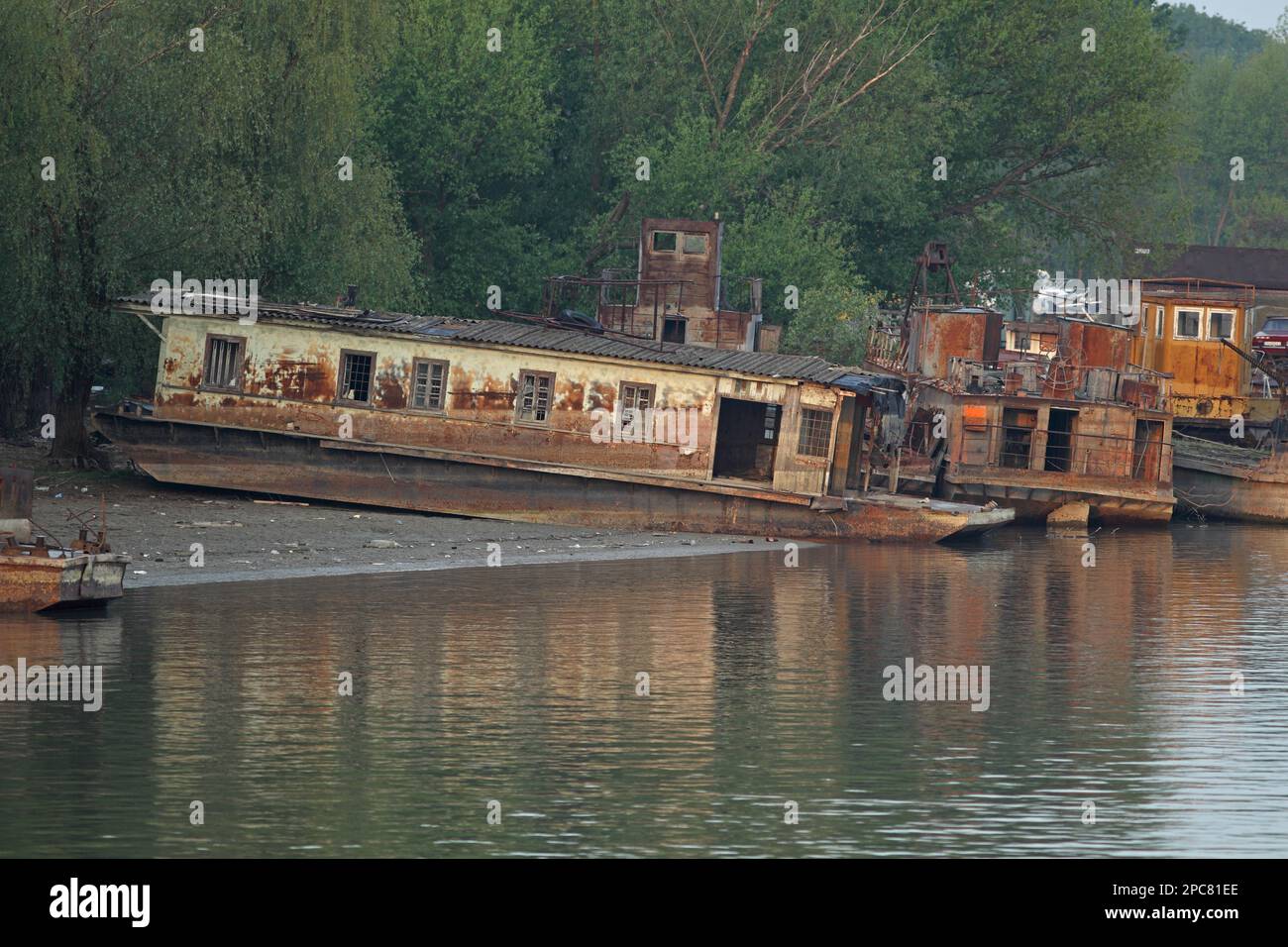 Rusting boats at edge of river, Tulcea, River Danube, Danube Delta ...