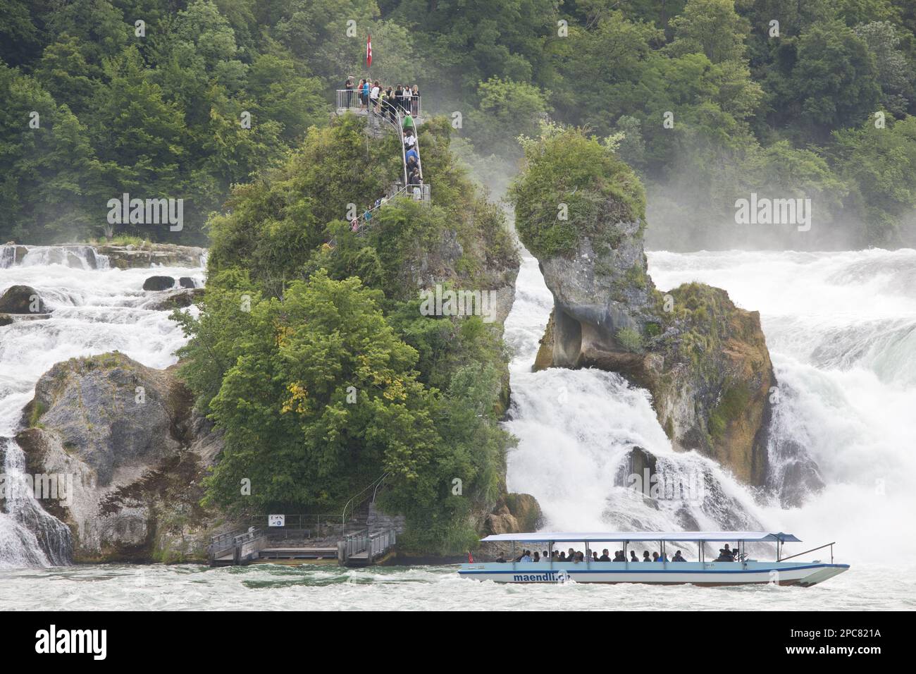Tourist boat and visitors at the largest shallow waterfall in Europe ...