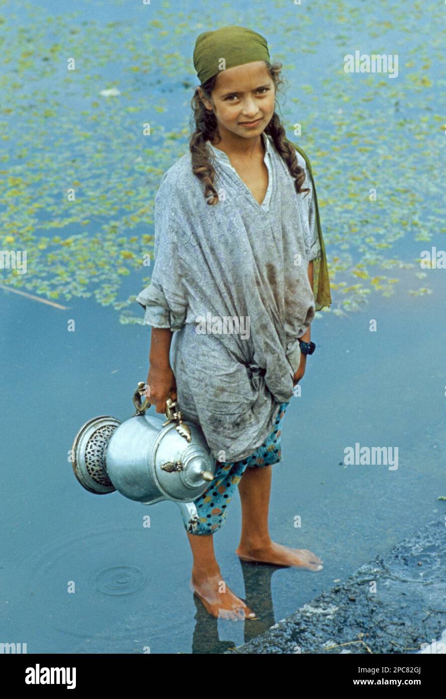 Kashmiri girl standing in a watercraft, Dal Lake, Srinagar, Kashmir ...
