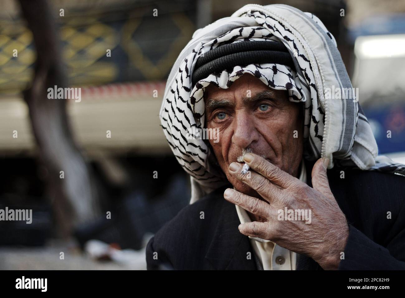 Market vendor, man smoking cigarette, close-up of head, Amman, Jordan ...