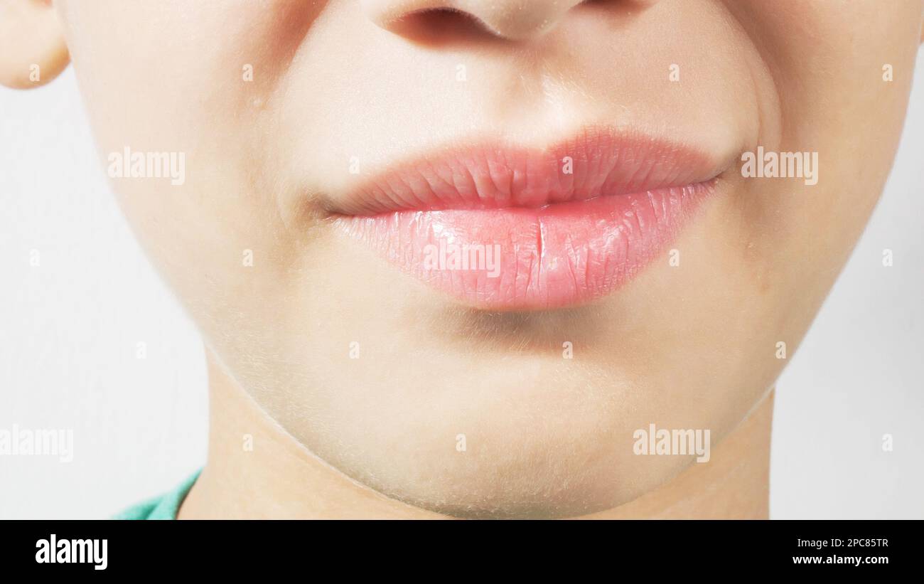 boy, kid smiles with his mouth closed, closeup of a child mouth ...