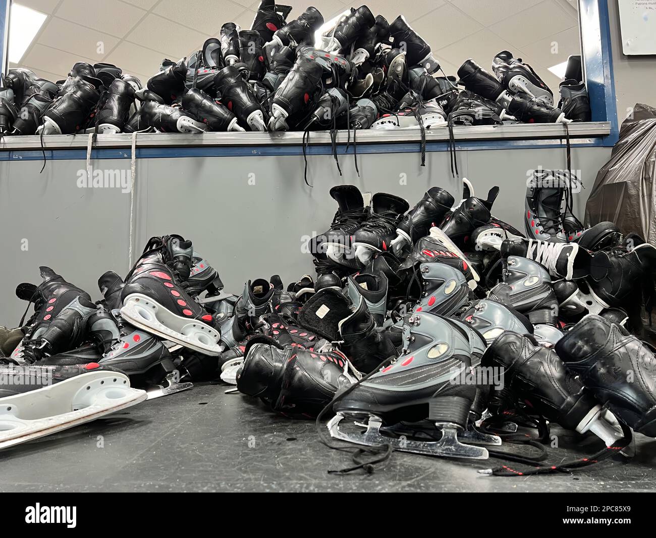 Pile of ice skates at the rental return window Stock Photo - Alamy