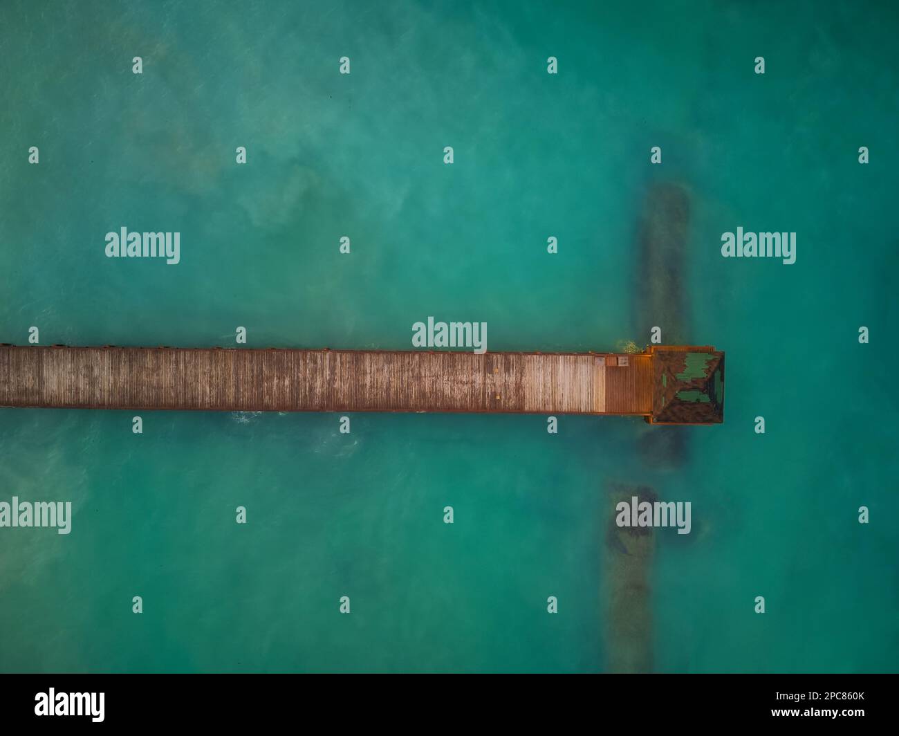 Wooden bridge in the sea. Aerial view. Smooth water surface and bridge ...