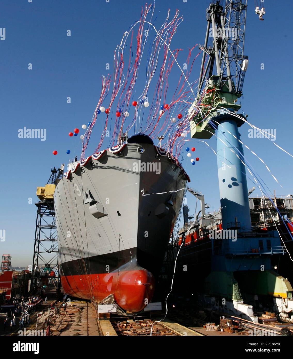 Streamers fly from the bow of the USNS Alan Shepard as the ship is ...