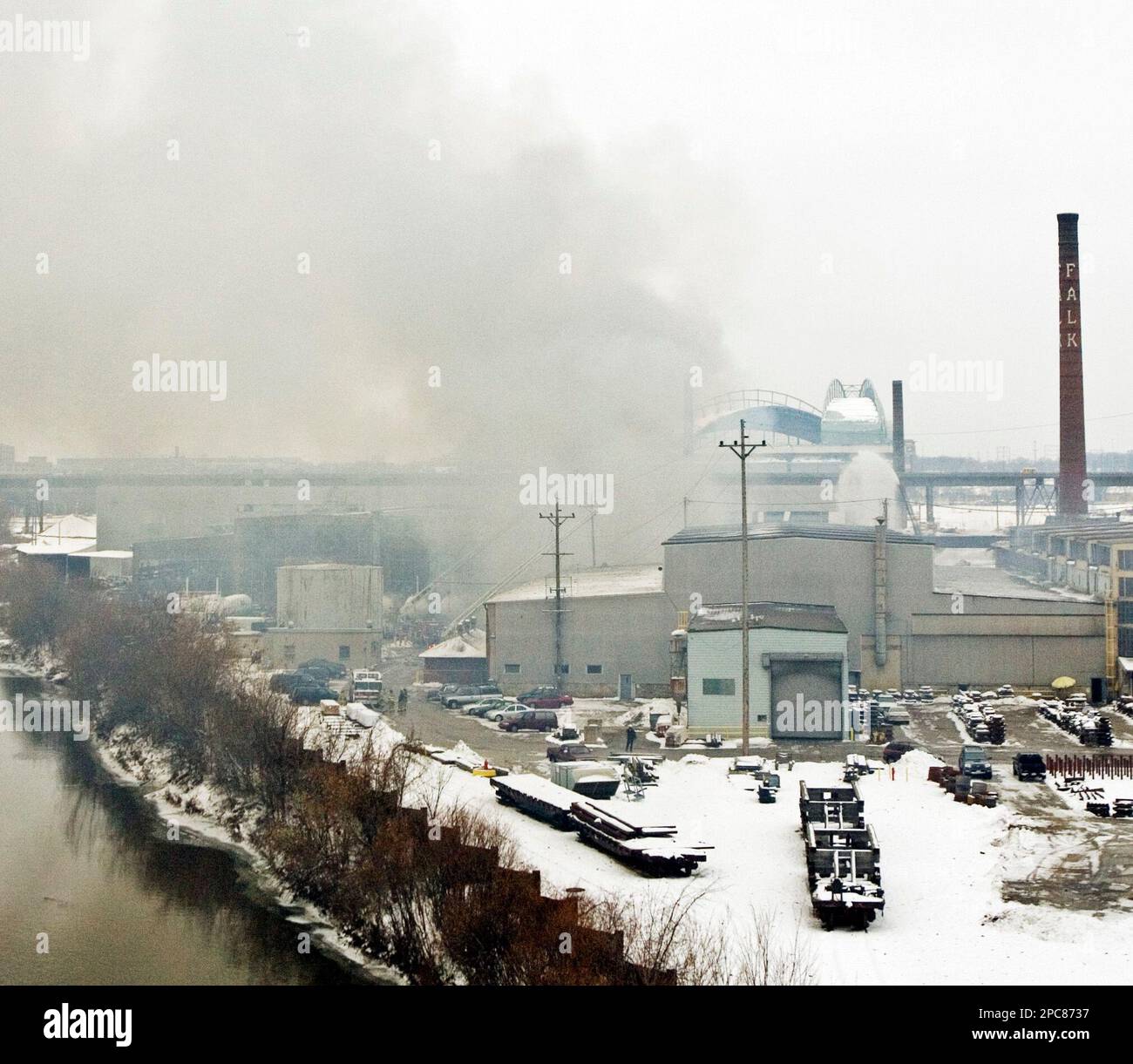 Smoke rises as firefighters work on a building after an explosion ...