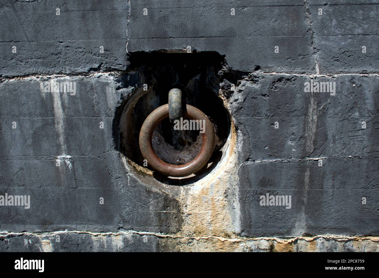 Large metal ring recessed in a black stone wall at Fort Pickens Stock ...