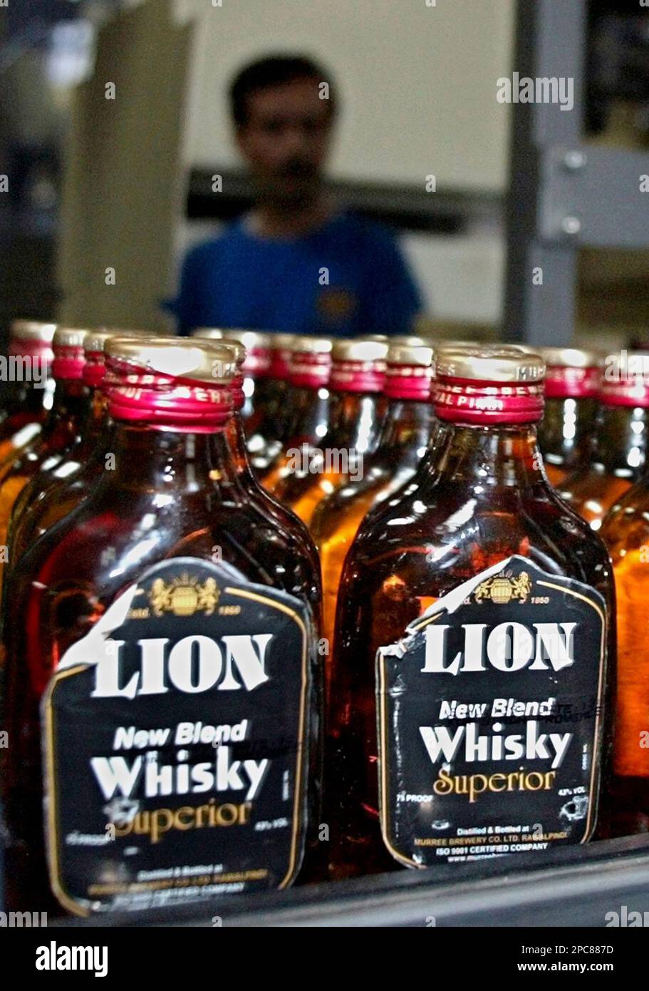 An employee supervises final stage of whiskey preparation at Pakistan's ...