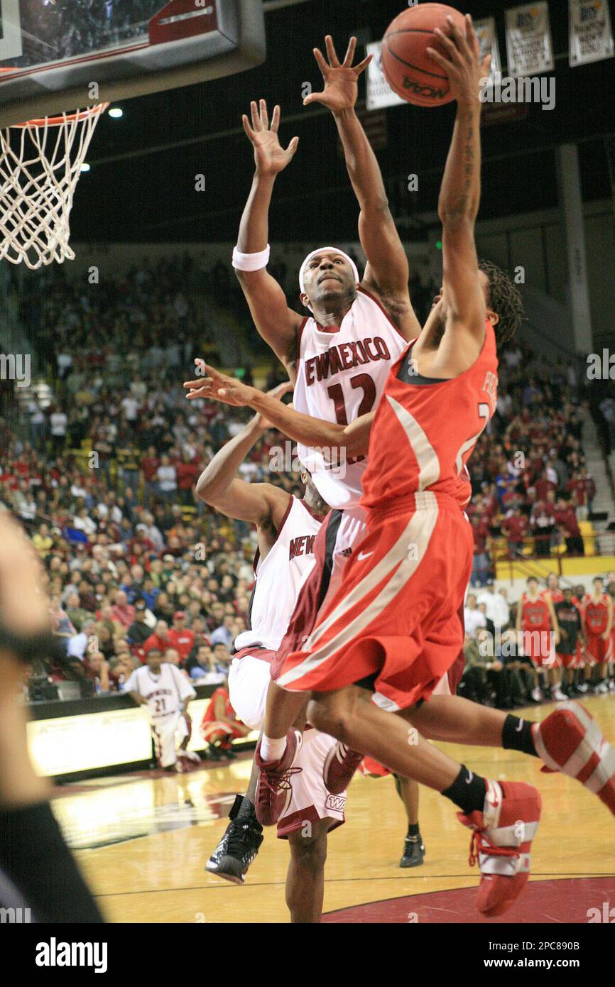 New Mexico's Darren Prentice has his shot blocked by New Mexico State's ...