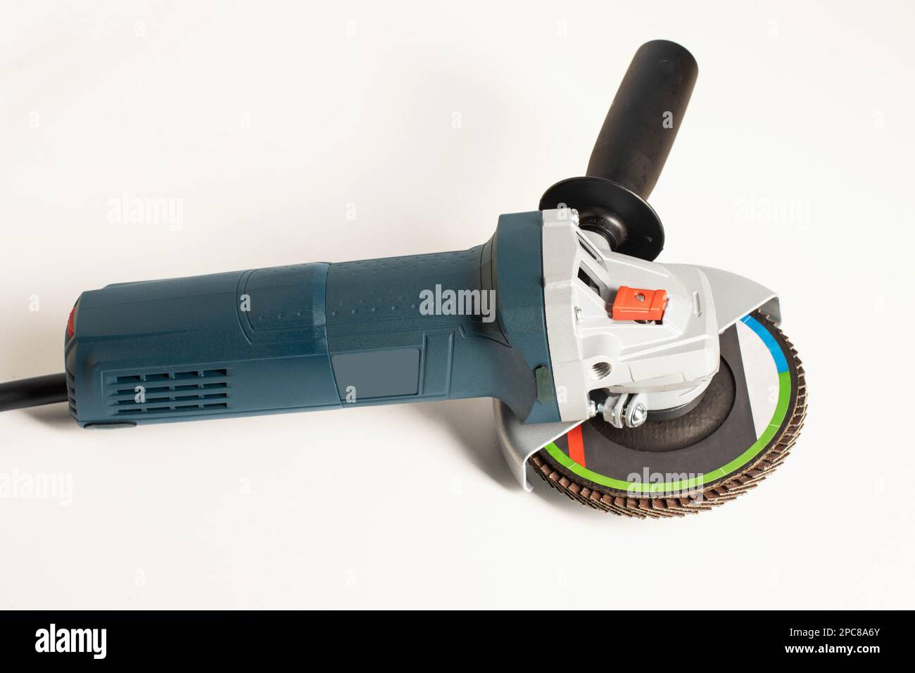 Modern professional angle grinder with a flap wheel on a white ...