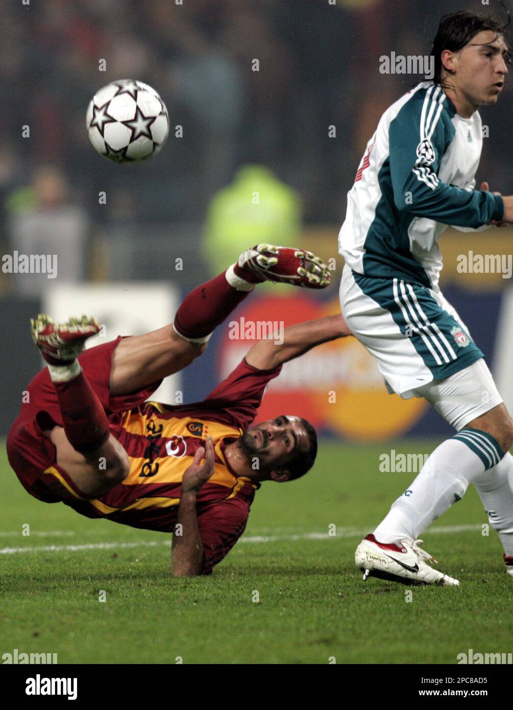 Galatasaray's Umit Karan, left, fights for the ball with Gabriel ...