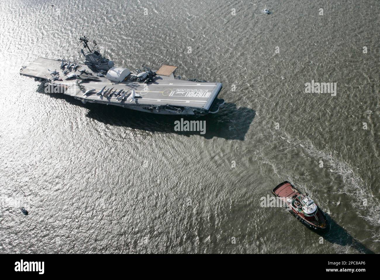 The USS Intrepid aircraft carrier is moved down the Hudson River ...