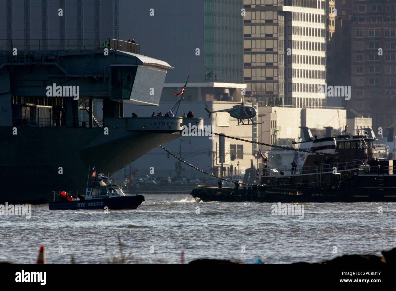 The USS Intrepid is pulled by tug boats as it heads towards its dry ...