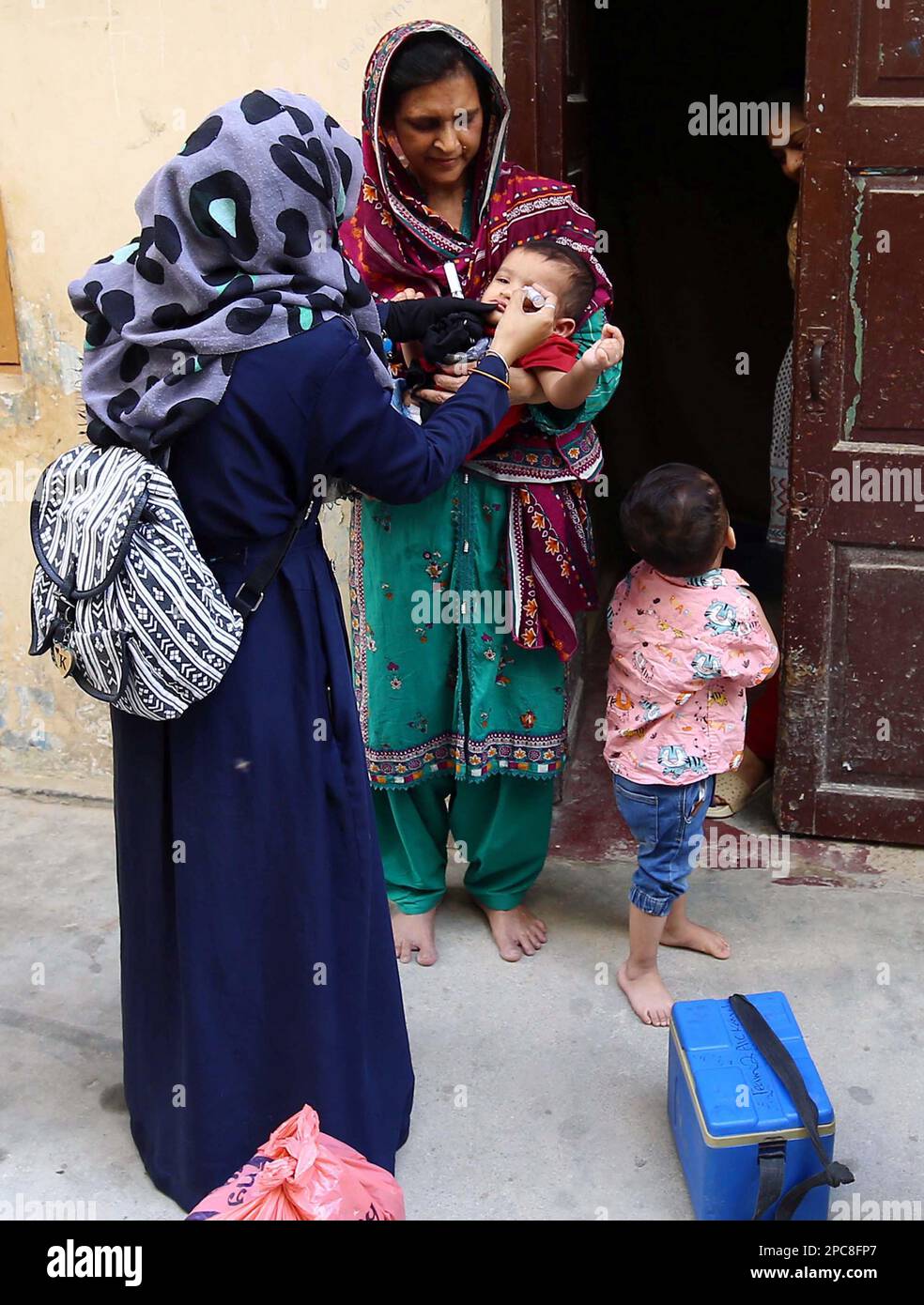 Health worker administrates polio-vaccine drops to a child during anti ...