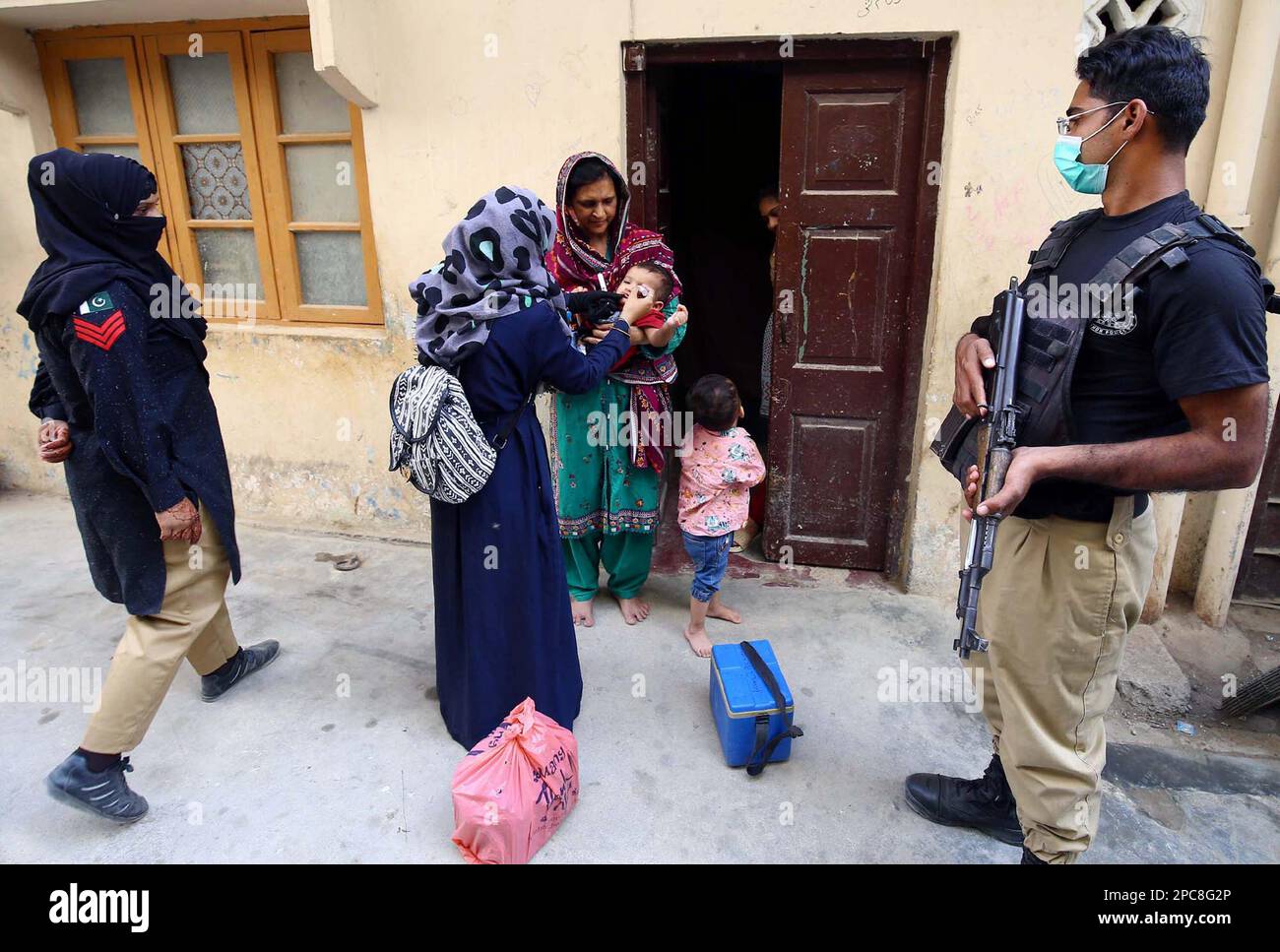 Health worker administrates polio-vaccine drops to a child during anti ...