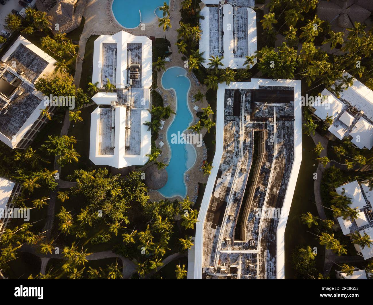 Shooting from a drone. Palm trees, swimming pools, roofs of tall ...