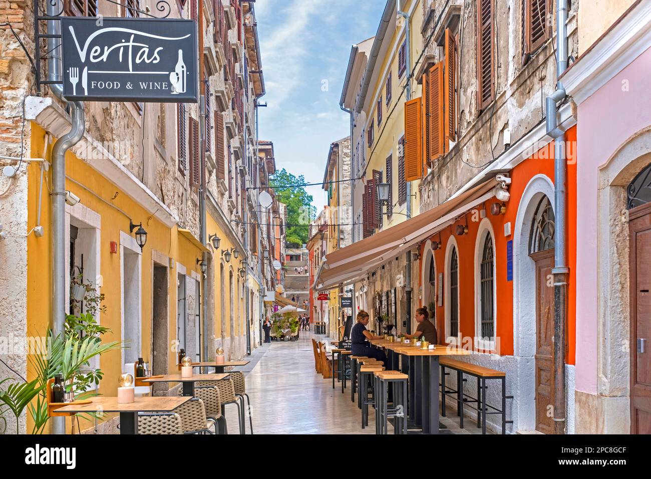 Narrow alley with restaurants in the historic town centre of the city ...