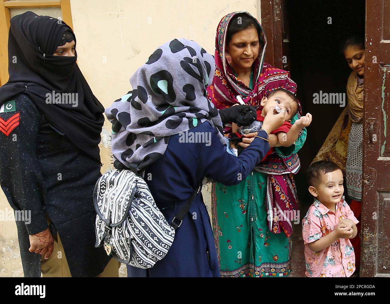 Health worker administrates polio-vaccine drops to a child during anti ...