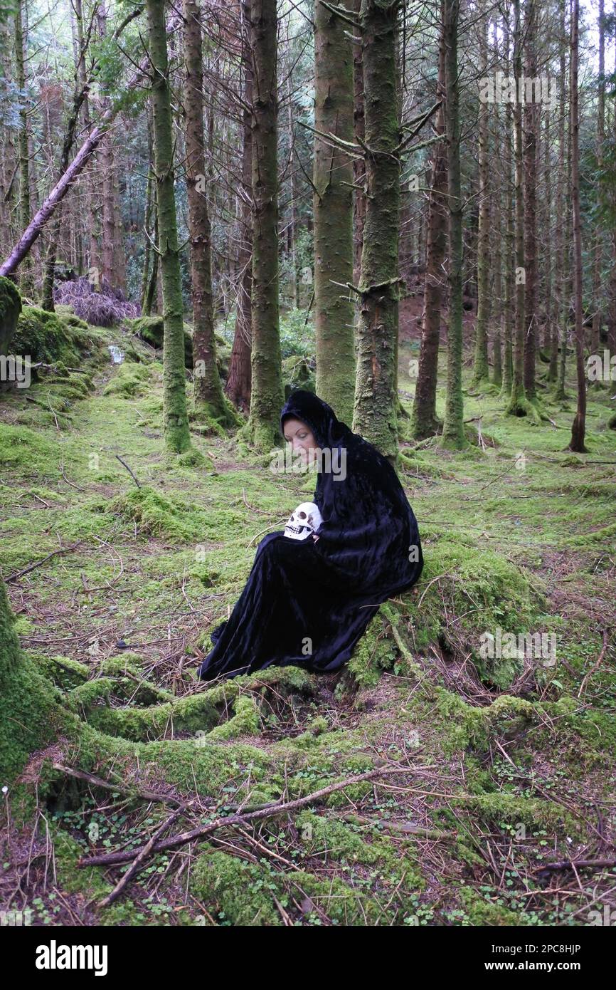 Mature female witch with a human skull - John Gollop Stock Photo - Alamy