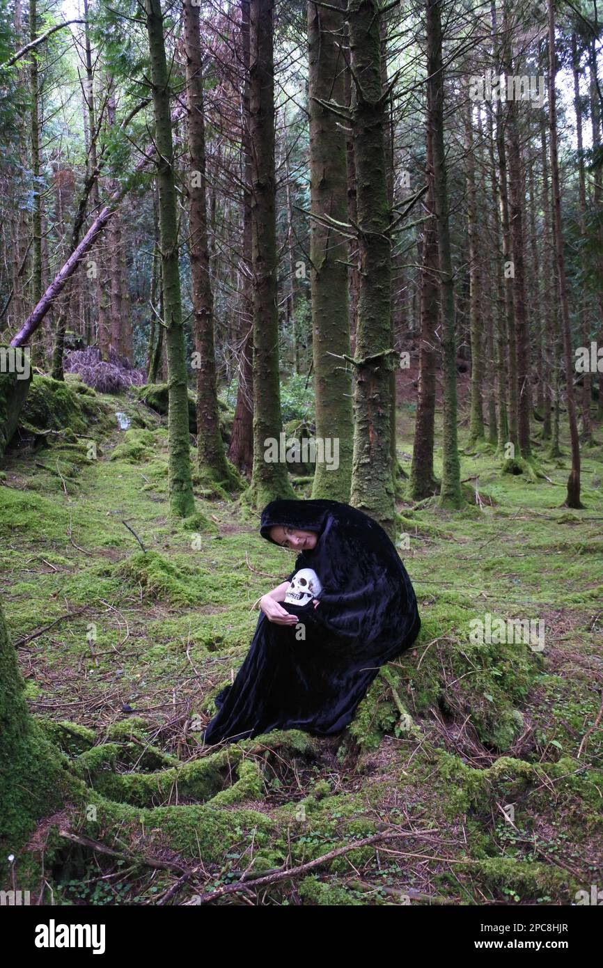 Mature female witch with a human skull - John Gollop Stock Photo - Alamy