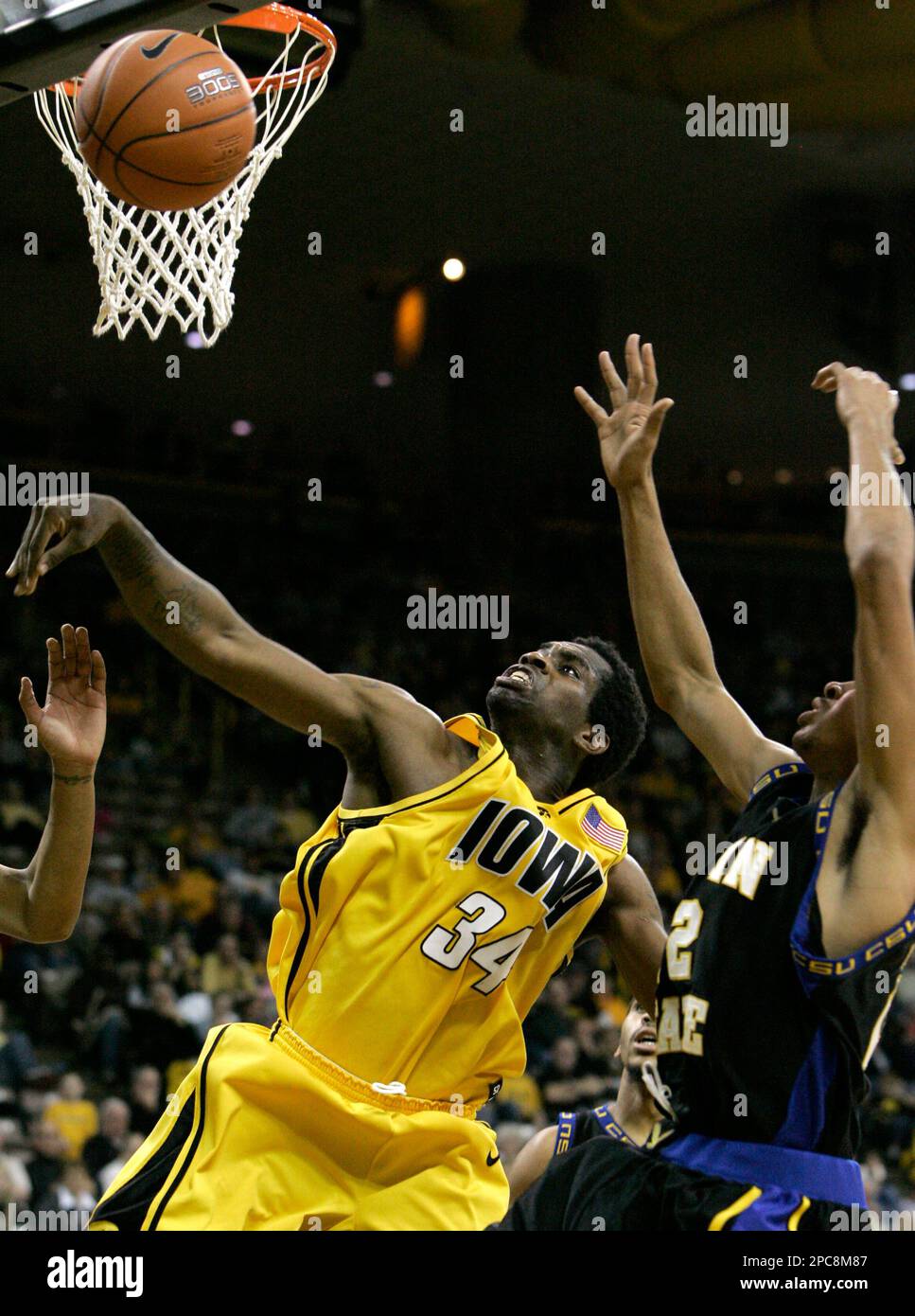 Iowa's Tyler Smith, left, fights for a rebound with Coppin State's ...
