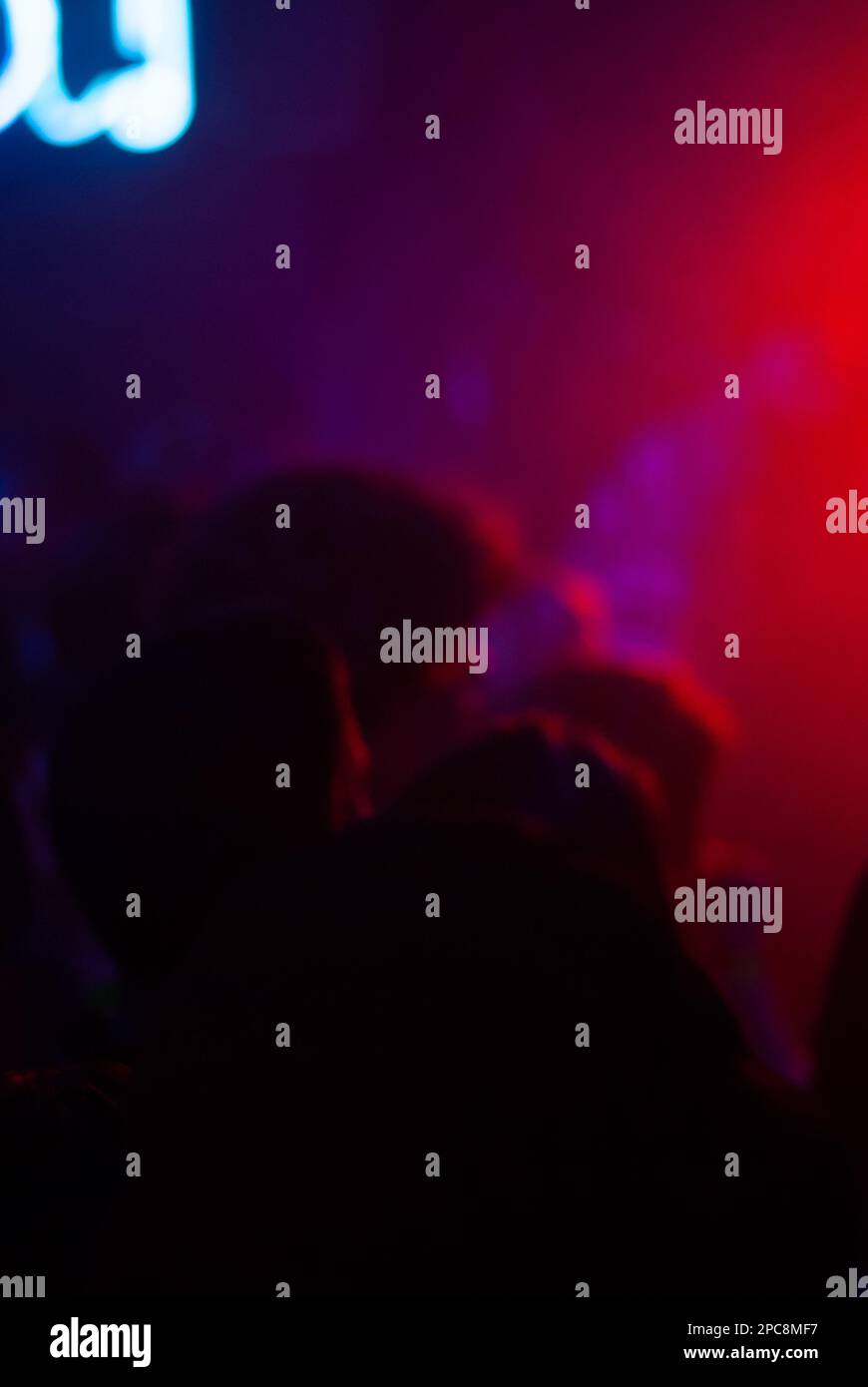 Crowd in night club in pink light Stock Photo - Alamy