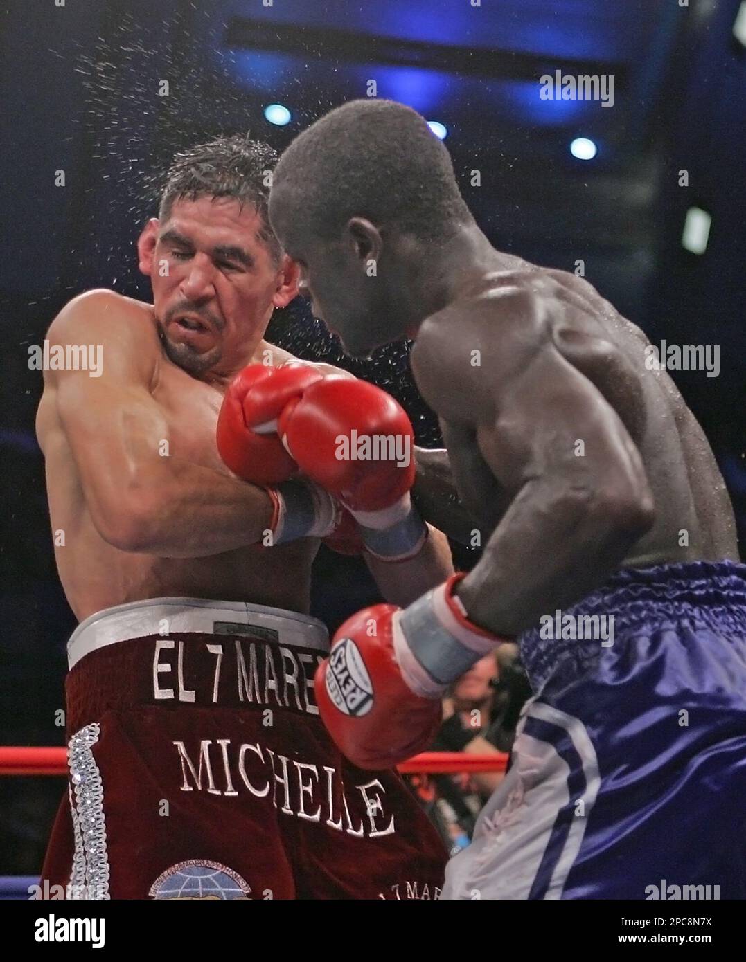 Joshua Clottey, right, of New York, punches Antonio Margarito, of ...