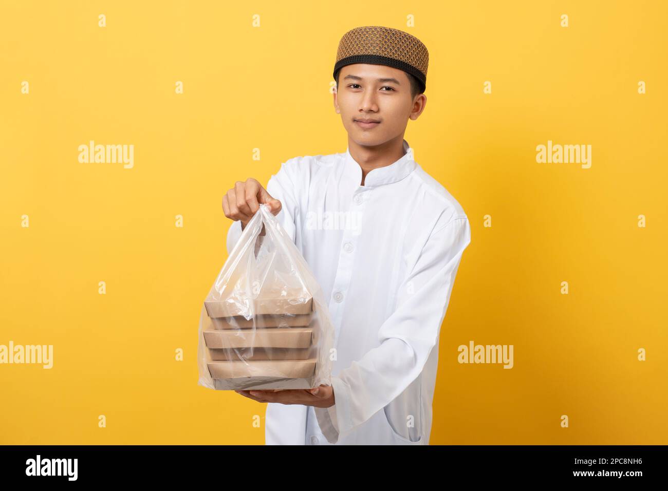 Young handsome asian muslim man giving alms or charity standing over ...