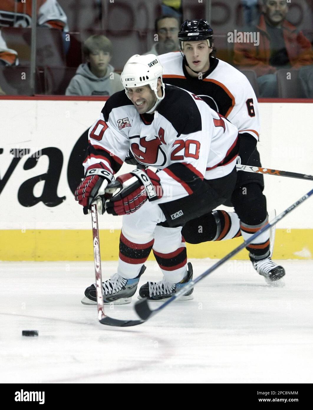 New Jersey Devils left wing Jay Pandolfo, left, chases the puck while ...