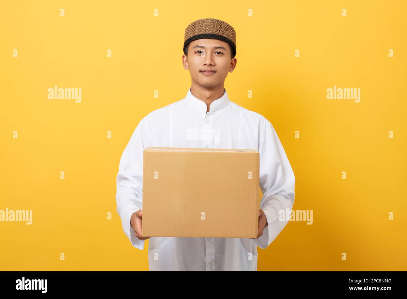 Young handsome asian muslim man giving alms or charity standing over ...