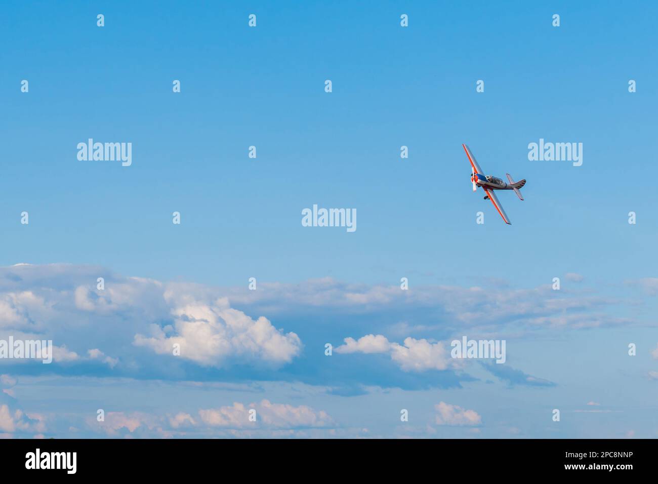 Light aircraft flying in blue sky and doing stunts Stock Photo - Alamy