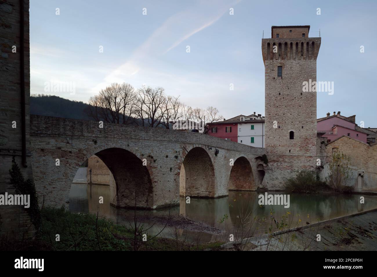Ancient roman stone bridge and medieval tower over the river Metauro in ...