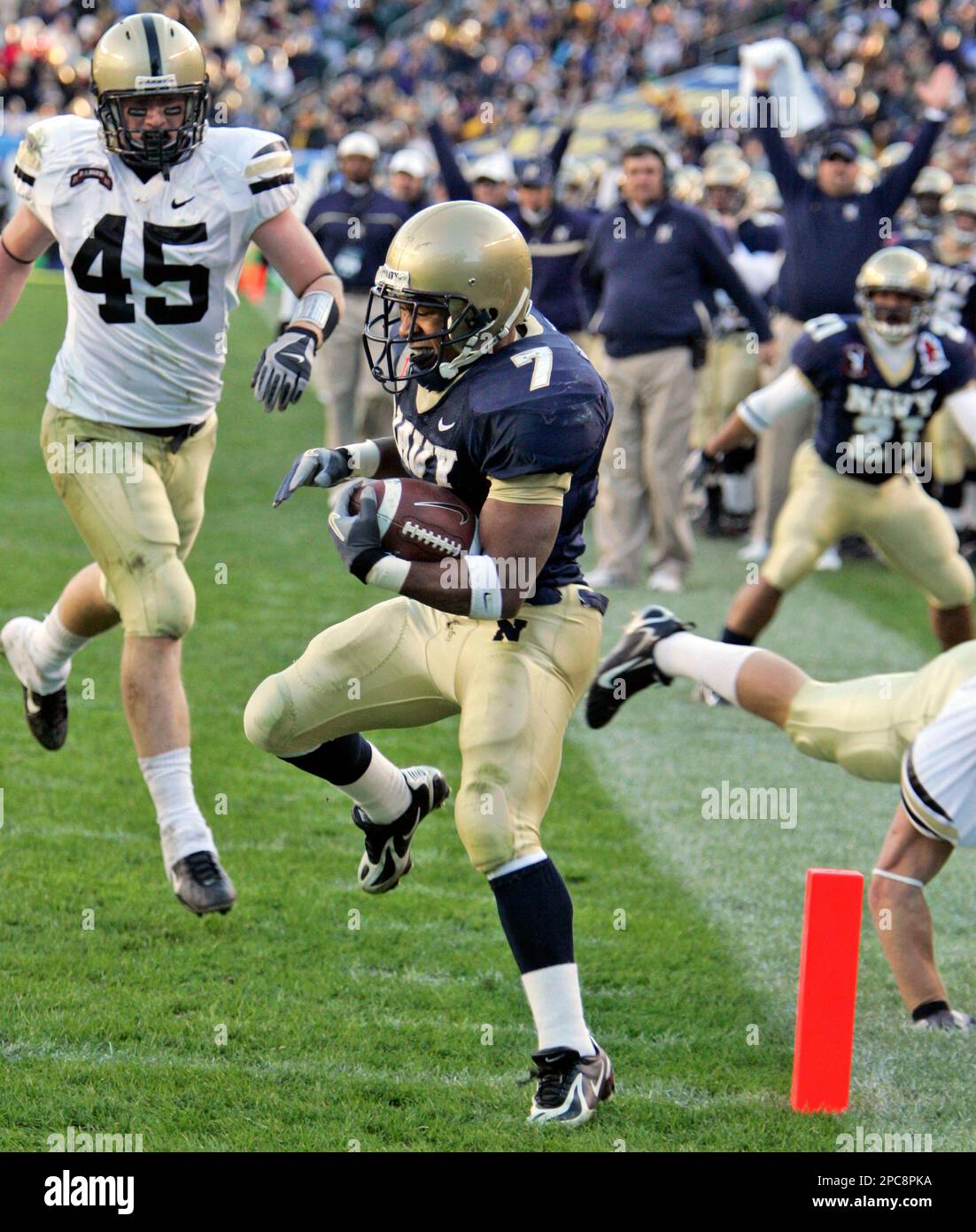 Navy back Reggie Campbell (7) scores on a 9-yard run as Army linebacker ...