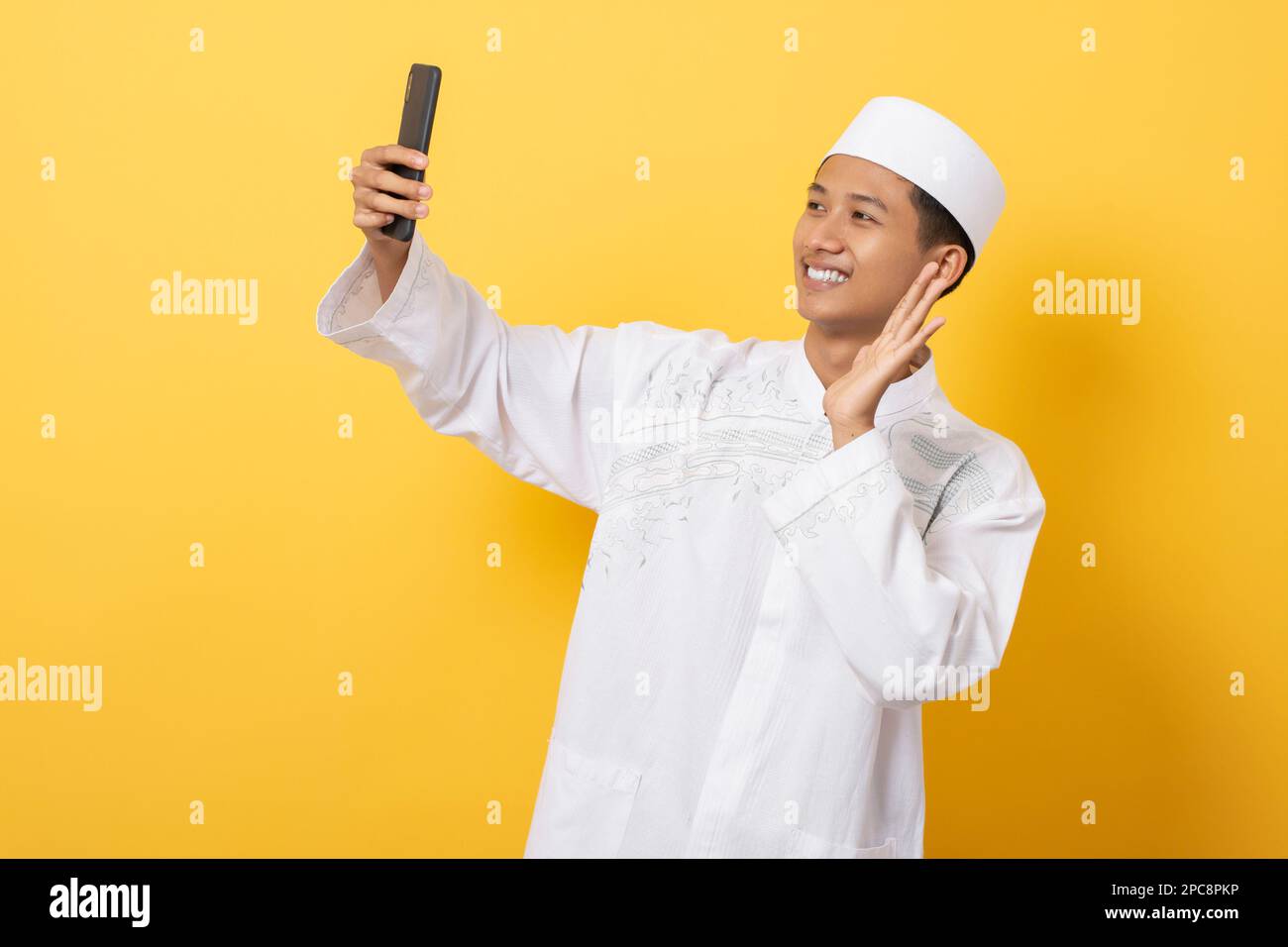 Young handsome asian muslim man smiling waving hand video call standing ...