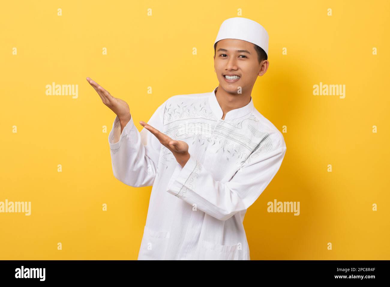 Young handsome asian muslim man standing over orange background ...