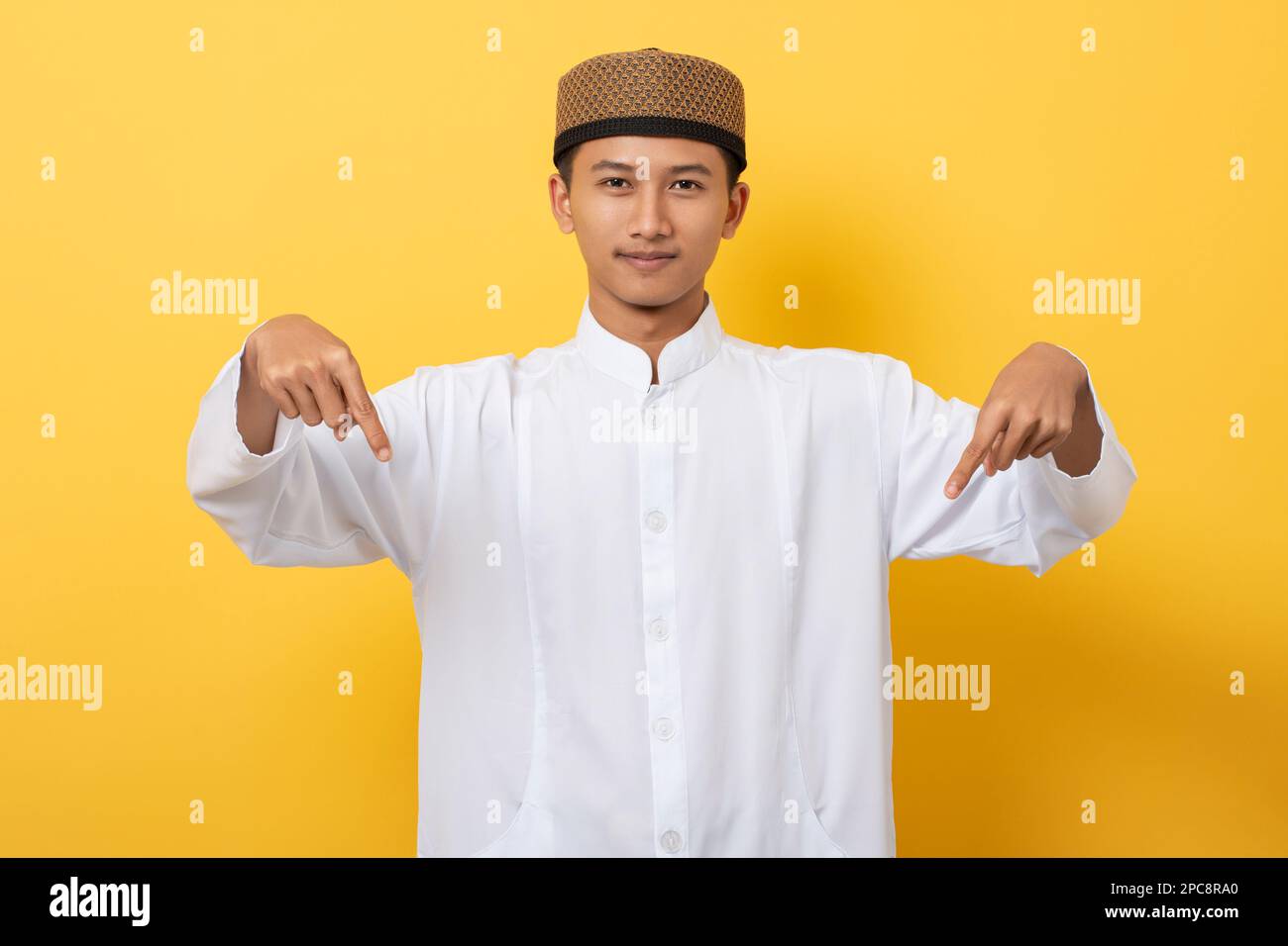 Young handsome asian muslim man standing over orange background ...