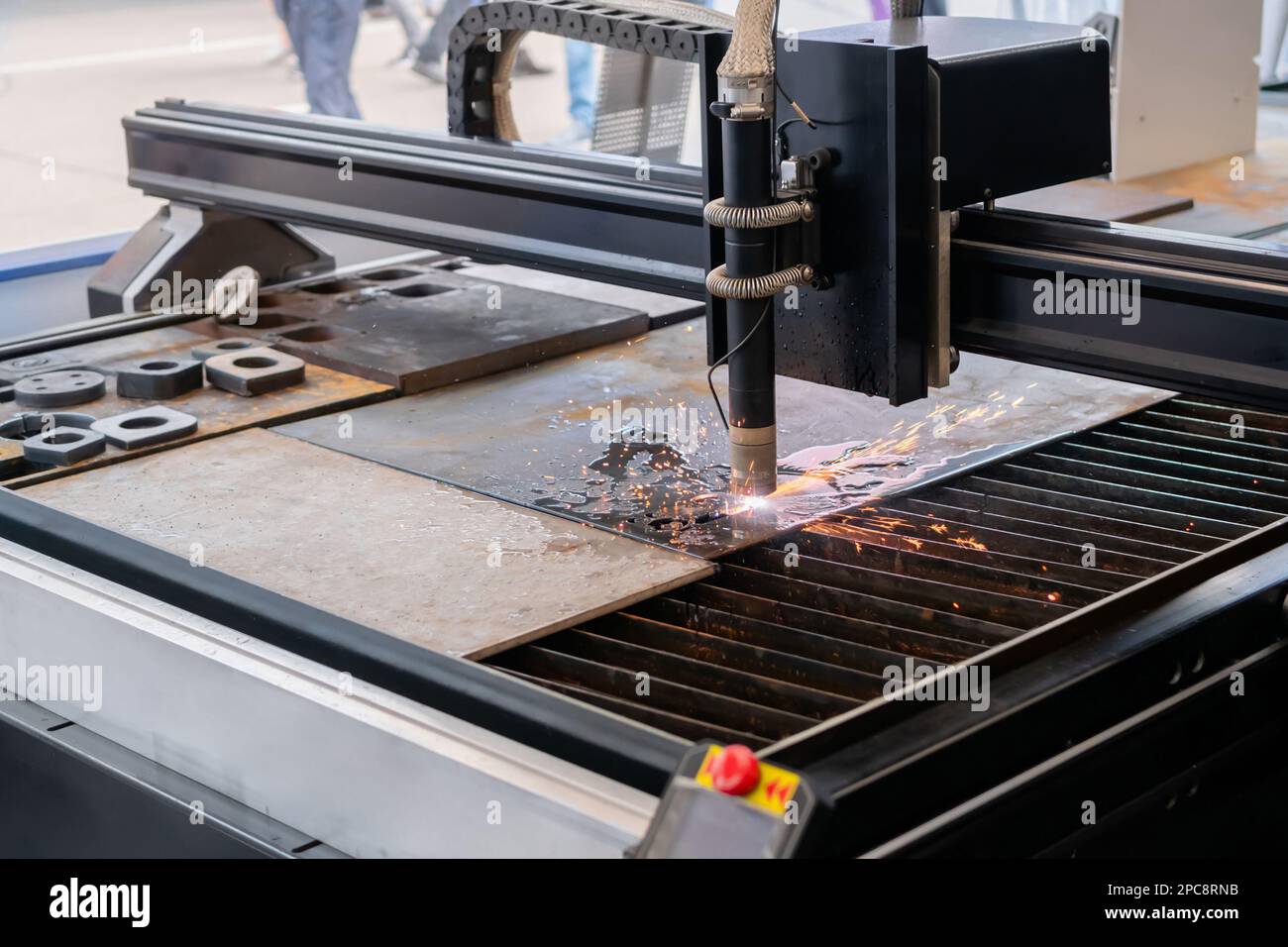 Plasma cutting machine working with sheet metal with sparks at factory ...