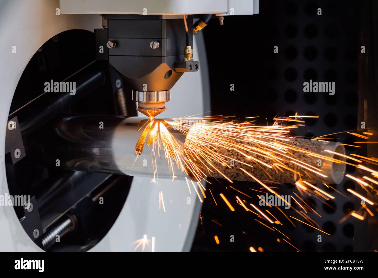 Cnc laser cutting machine working with cylindrical metal workpiece with ...